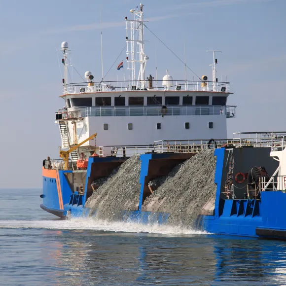 Side stone dumping vessel | Van Oord