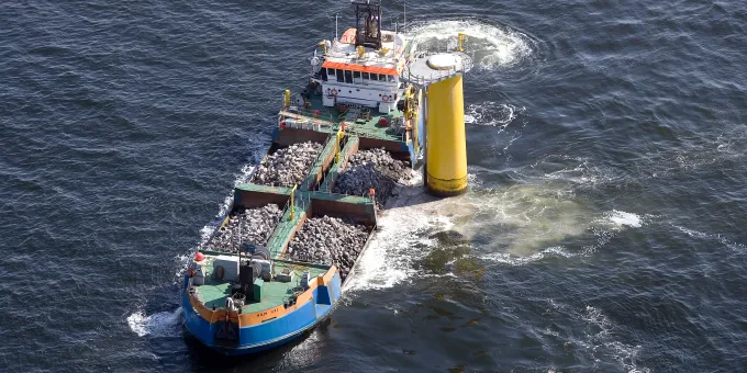 Side stone dumping vessel | Van Oord